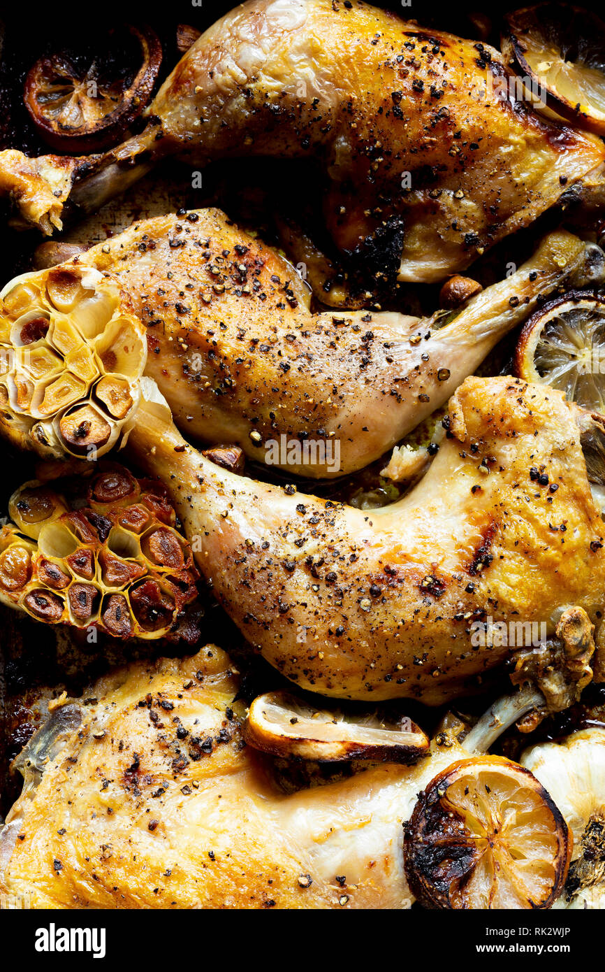 Roast Chicken Legs with sliced garlic Stock Photo - Alamy