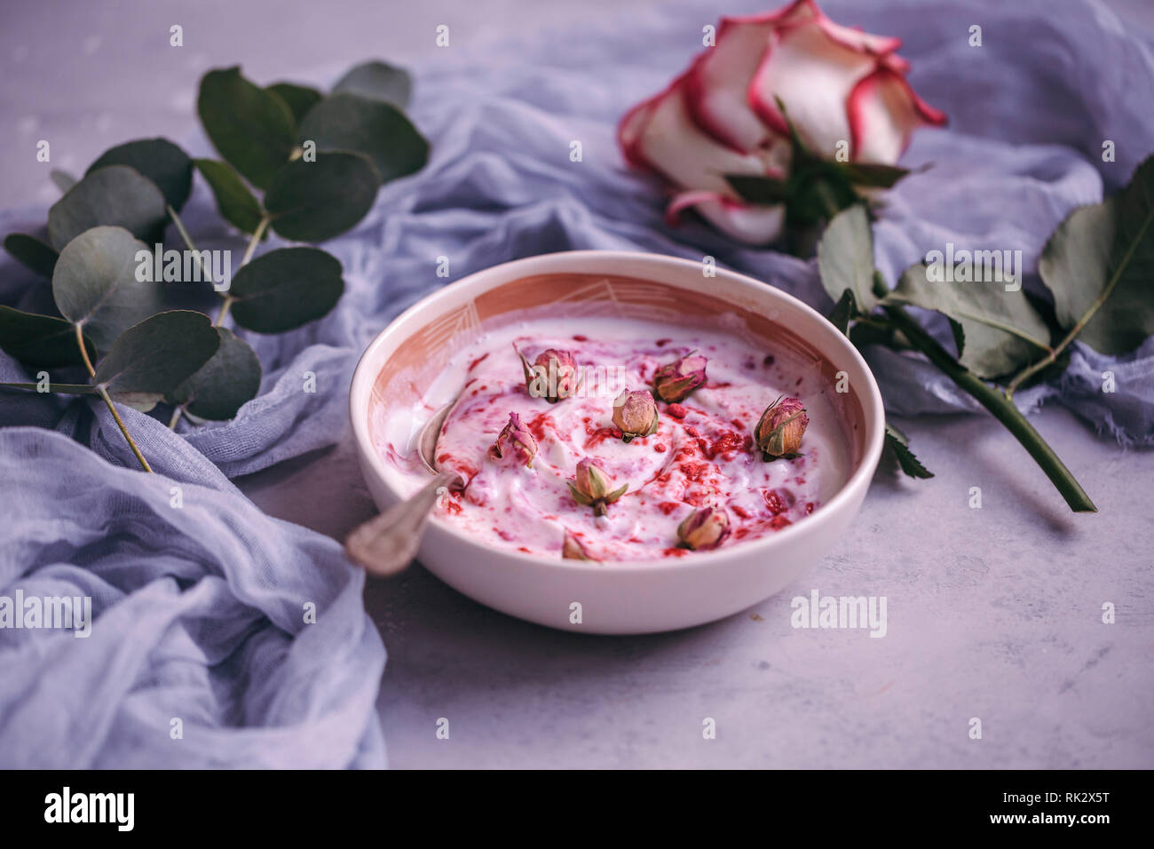 Bowl of yogurt with raspberry powder and dried rose buds Stock Photo ...