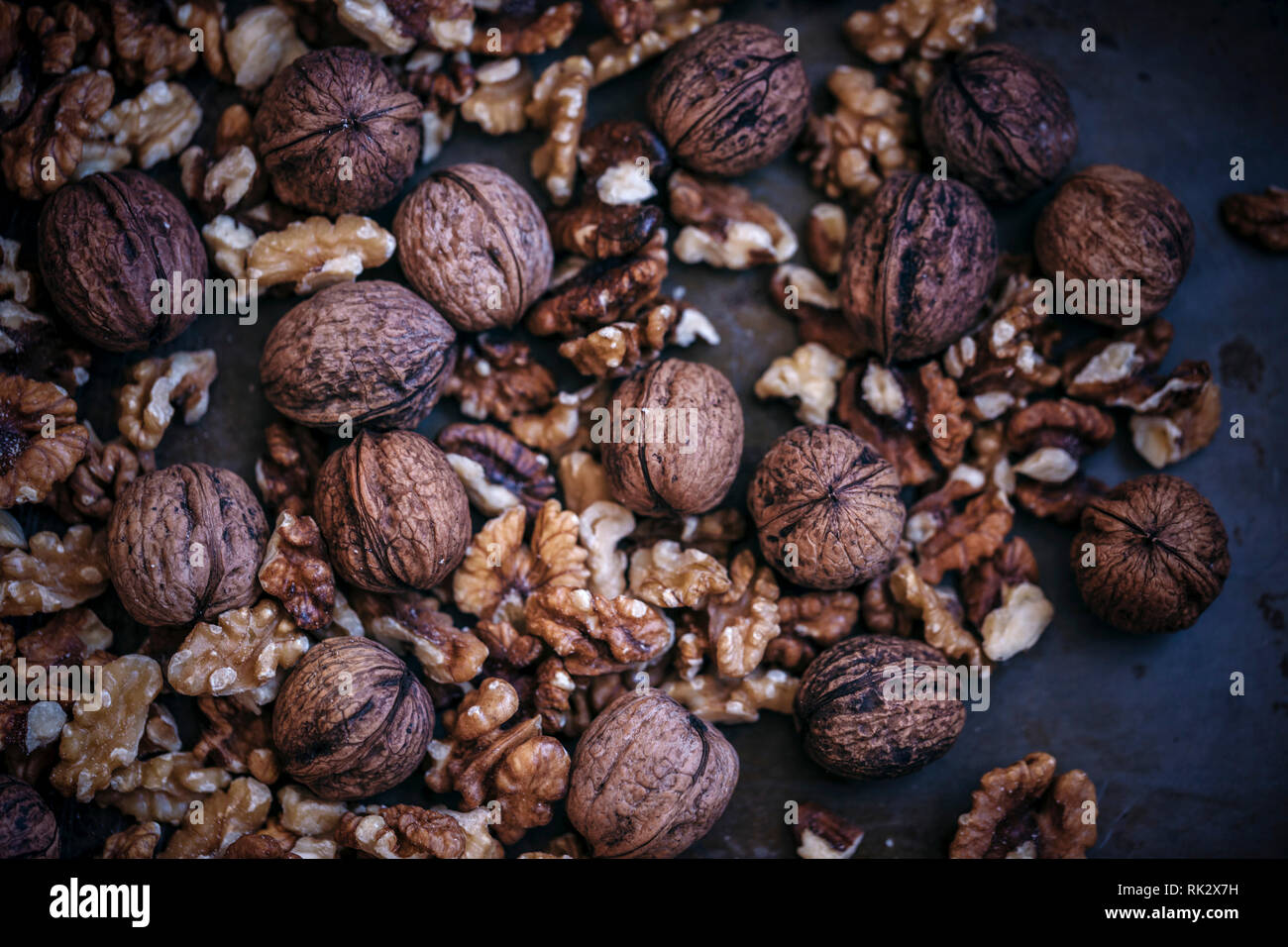 Mix of walnuts in shell and without shell on a black background Stock ...