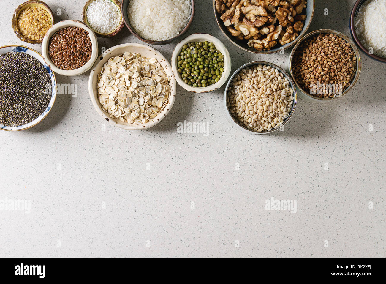 Variety of raw uncooked grains superfood cereal chia, linen, sesame ...