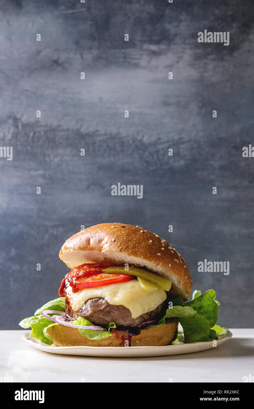 Close up of homemade classic burger in wheat bun with beef and veal ...