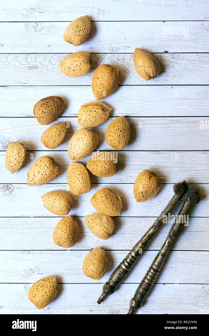 Whole almonds and a vintage nut cracker Stock Photo - Alamy