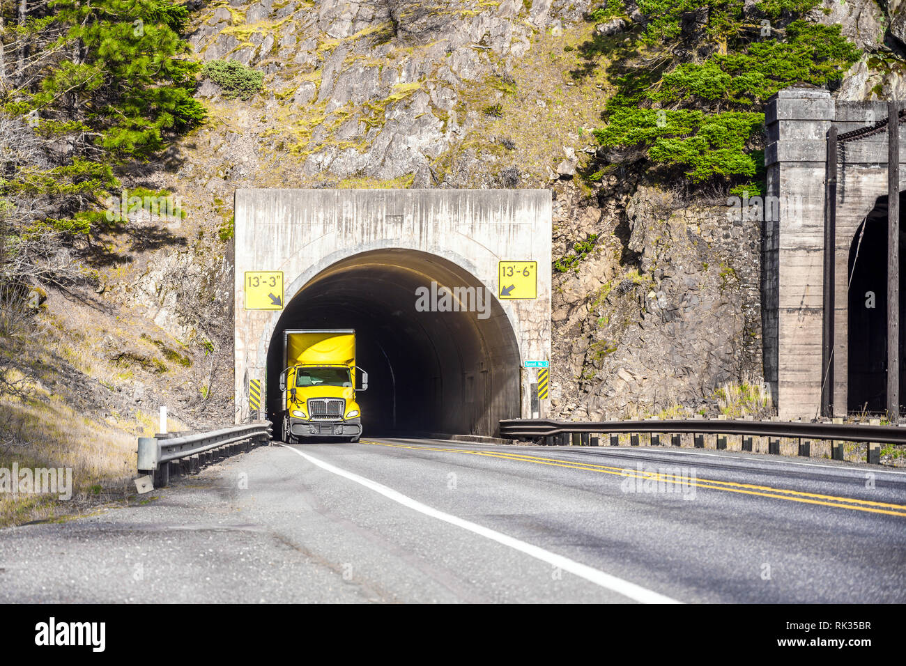 Big rig long haul yellow American semi truck transporting commercial ...