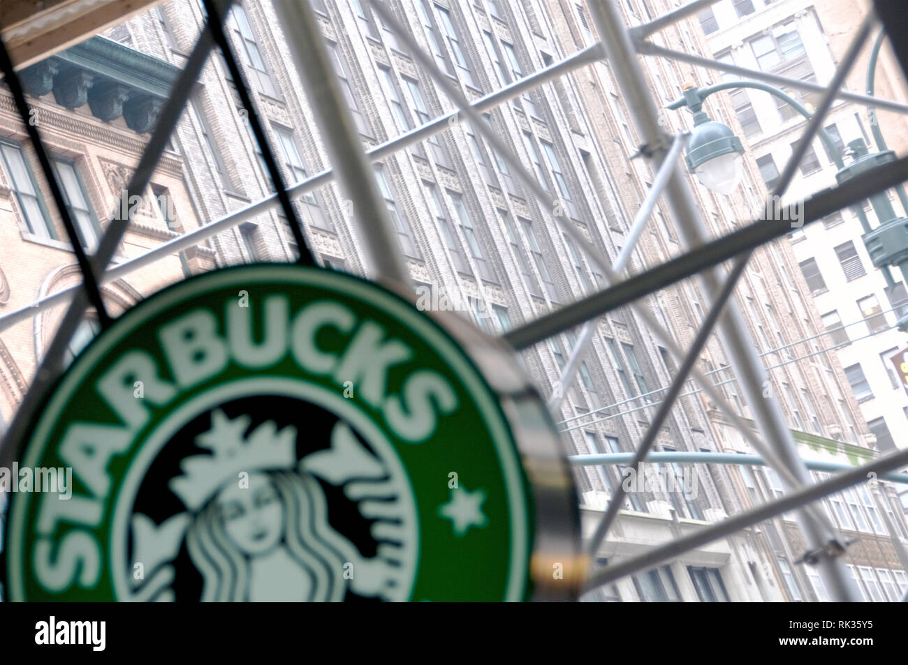 The lighted store logo of Starbucks store near the glass pane and ...