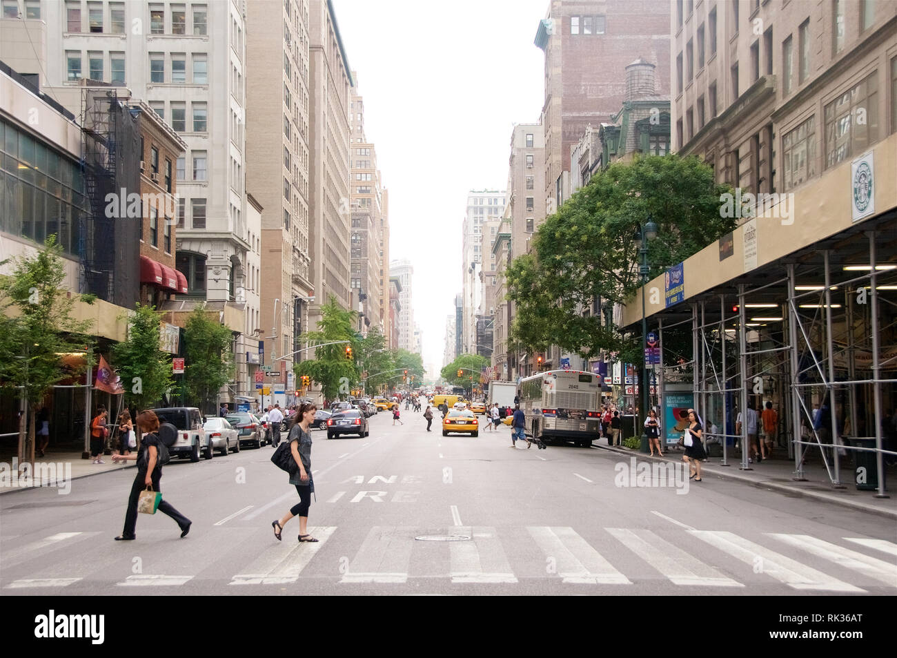 People crossing the pedestrian lane on one of the cross streets of 5th ...