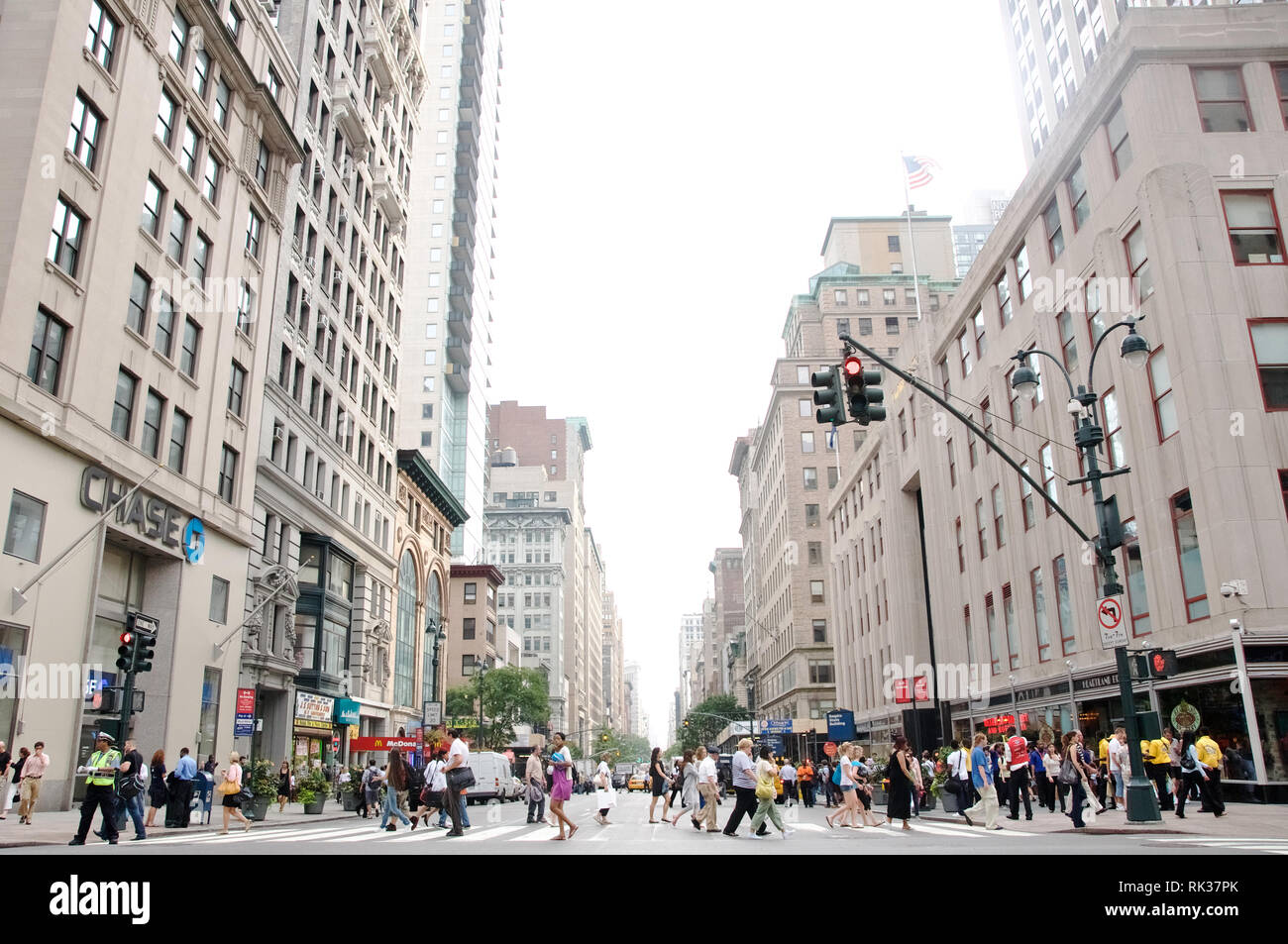 People crossing the pedestrian lane on one of the cross streets of 5th ...
