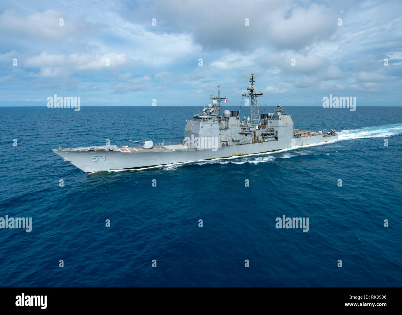 The guided-missile cruiser USS Mobile Bay (CG 53) cuts through the ...