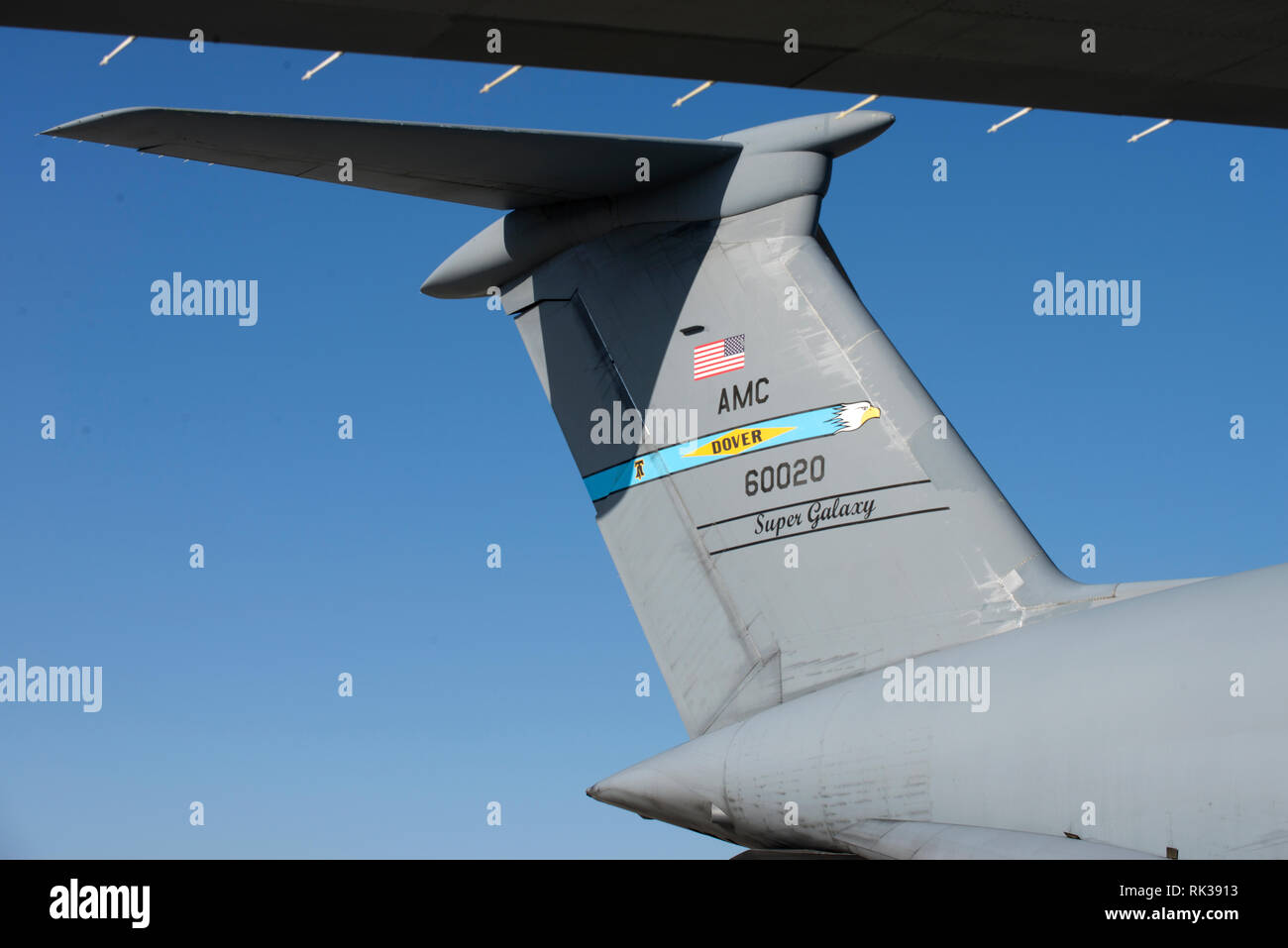 Airmen, Soldiers, and personnel prepare to load Apache Helicopters into ...