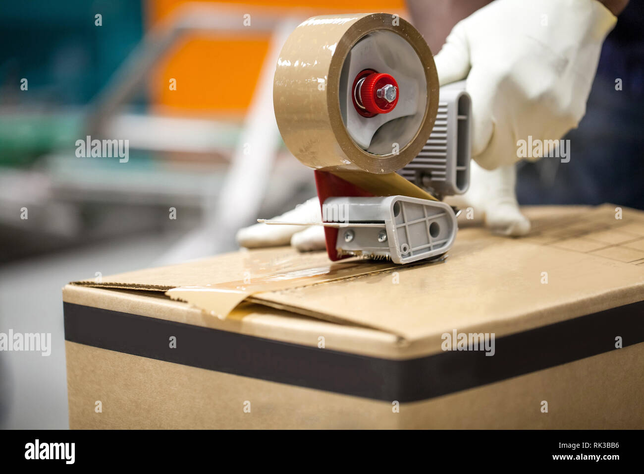Box being taped shut in packaging plant Stock Photo - Alamy