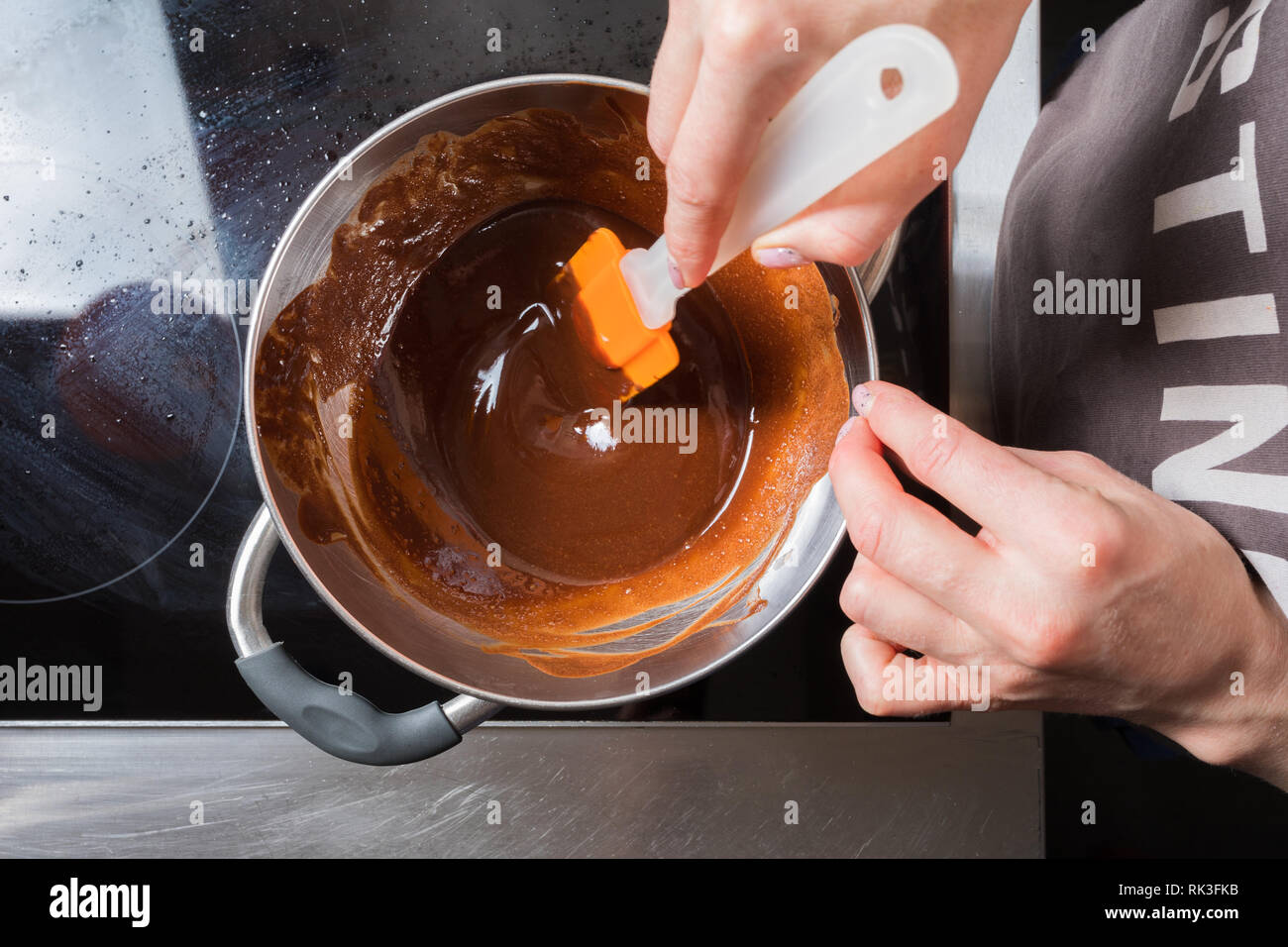 Top view of the process of melting chocolate in a water bath at home ...