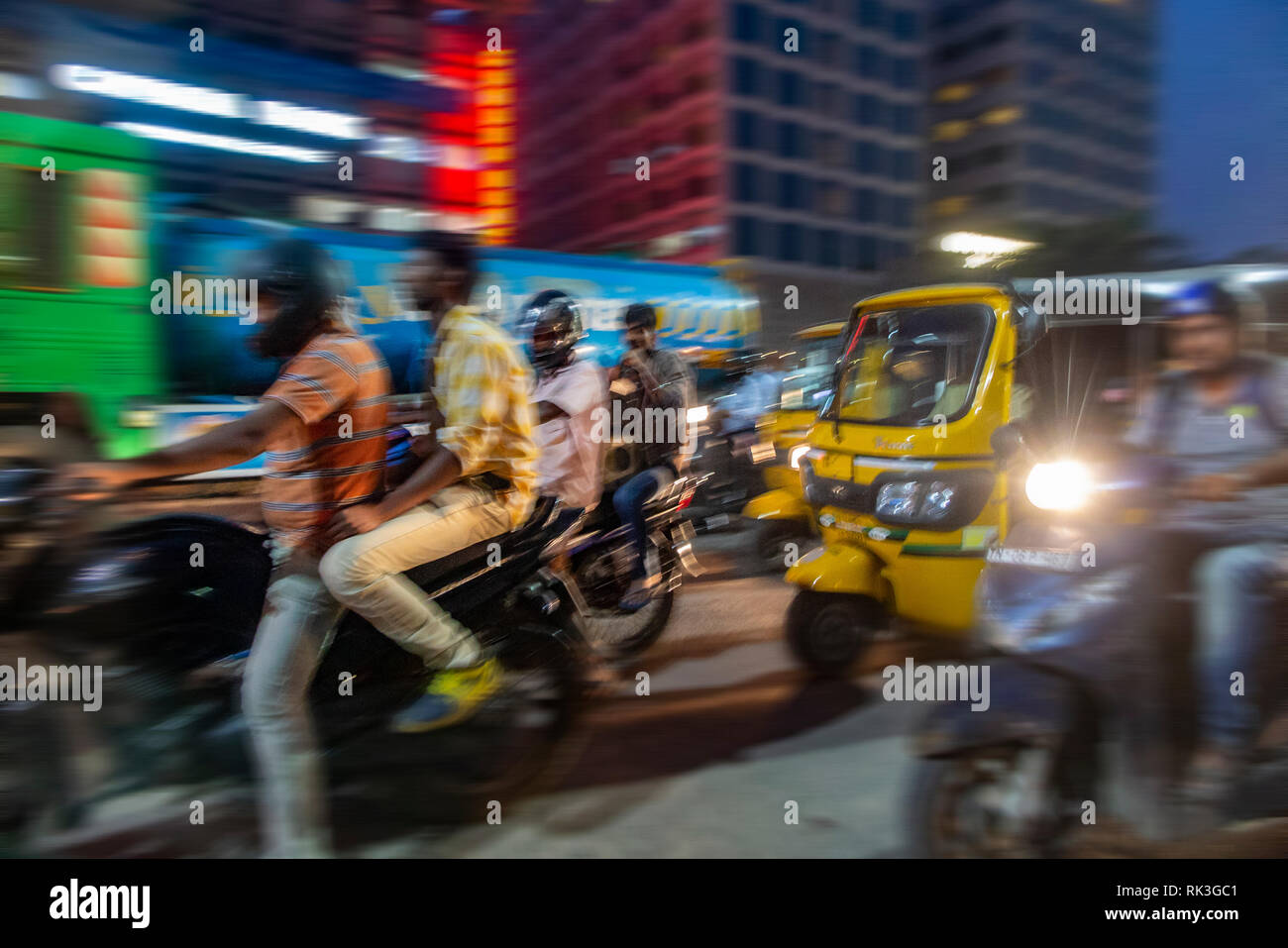 Evening rush hour with lots of motorbikes and a tuk tuk in Chennai ...