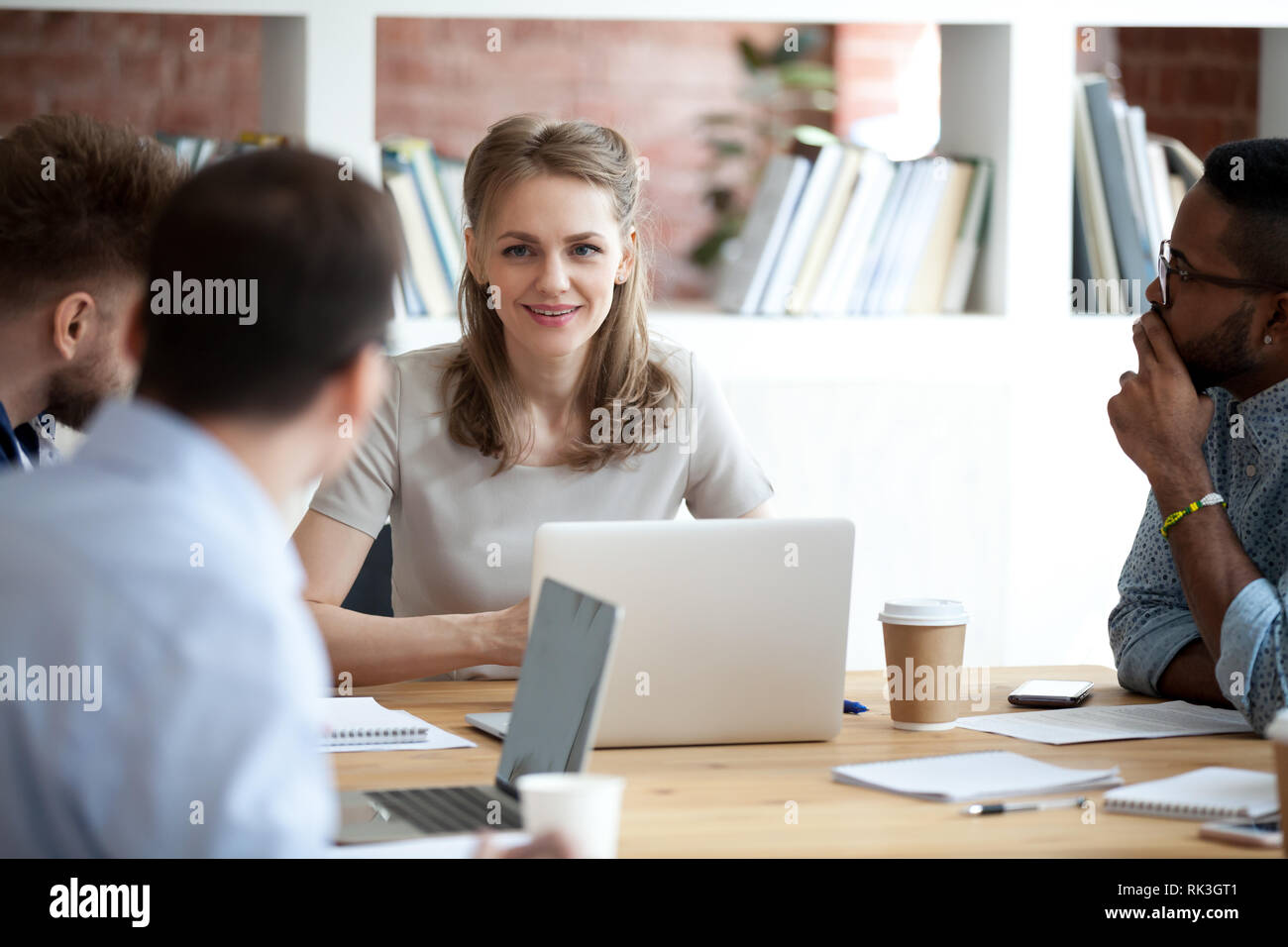 Female executive leader boss leading corporate multi-ethnic team ...