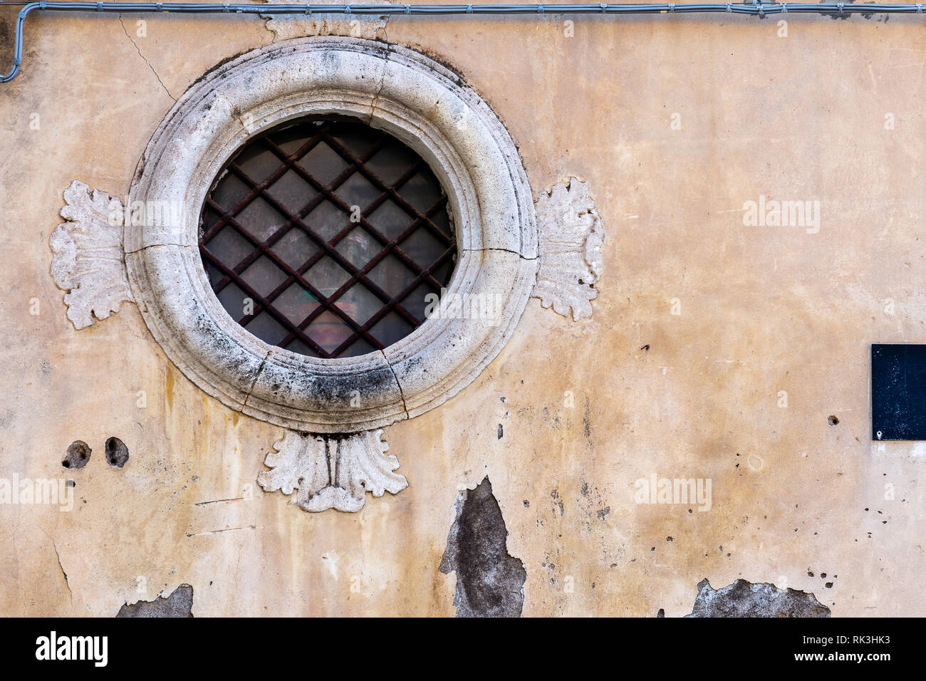The ancient circle window on stone wall, for background Stock Photo - Alamy