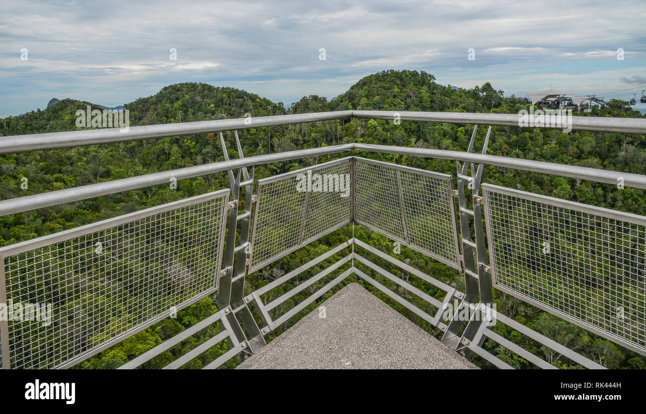 High altitude observation deck view with green forest and mountains ...