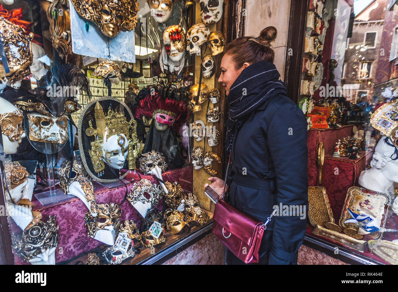 VENICE, ITALY - FEBRUARY 10 2018: Young woman who admires a typical ...
