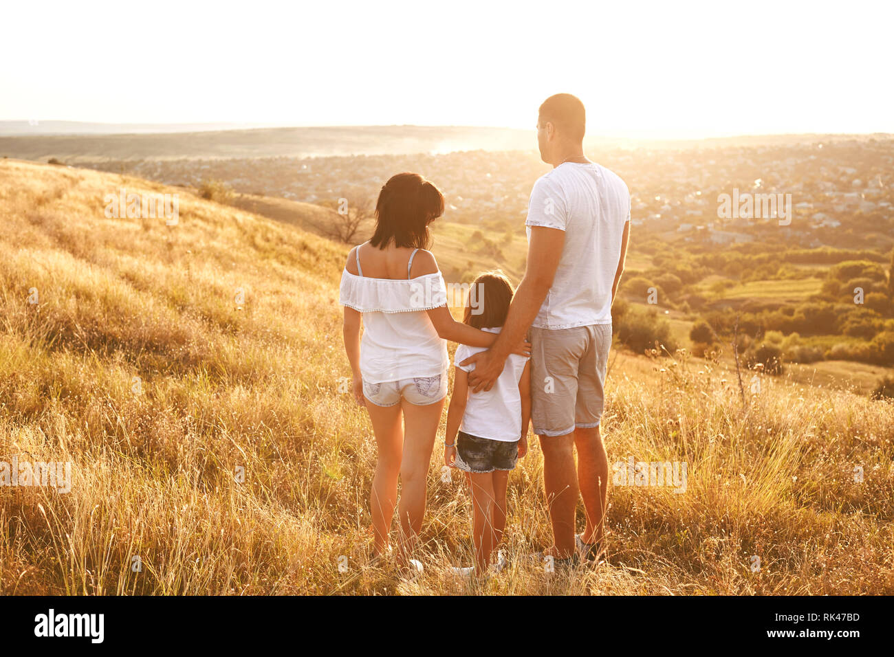 Happy family on nature in summer at sunset Stock Photo - Alamy