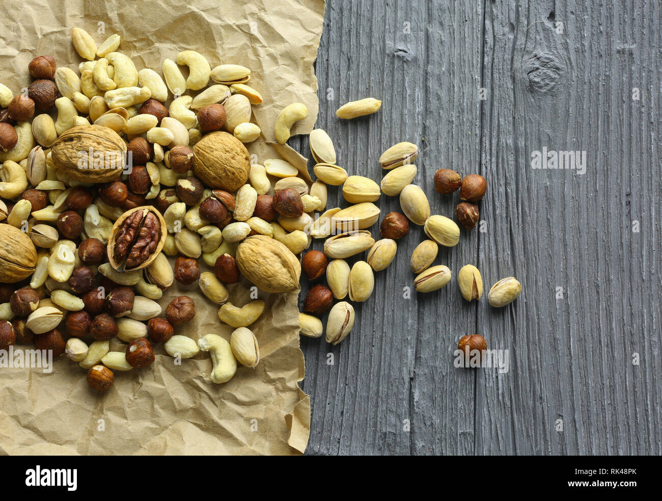 Assortment of nuts on a dark wooden table. View from above Stock Photo ...