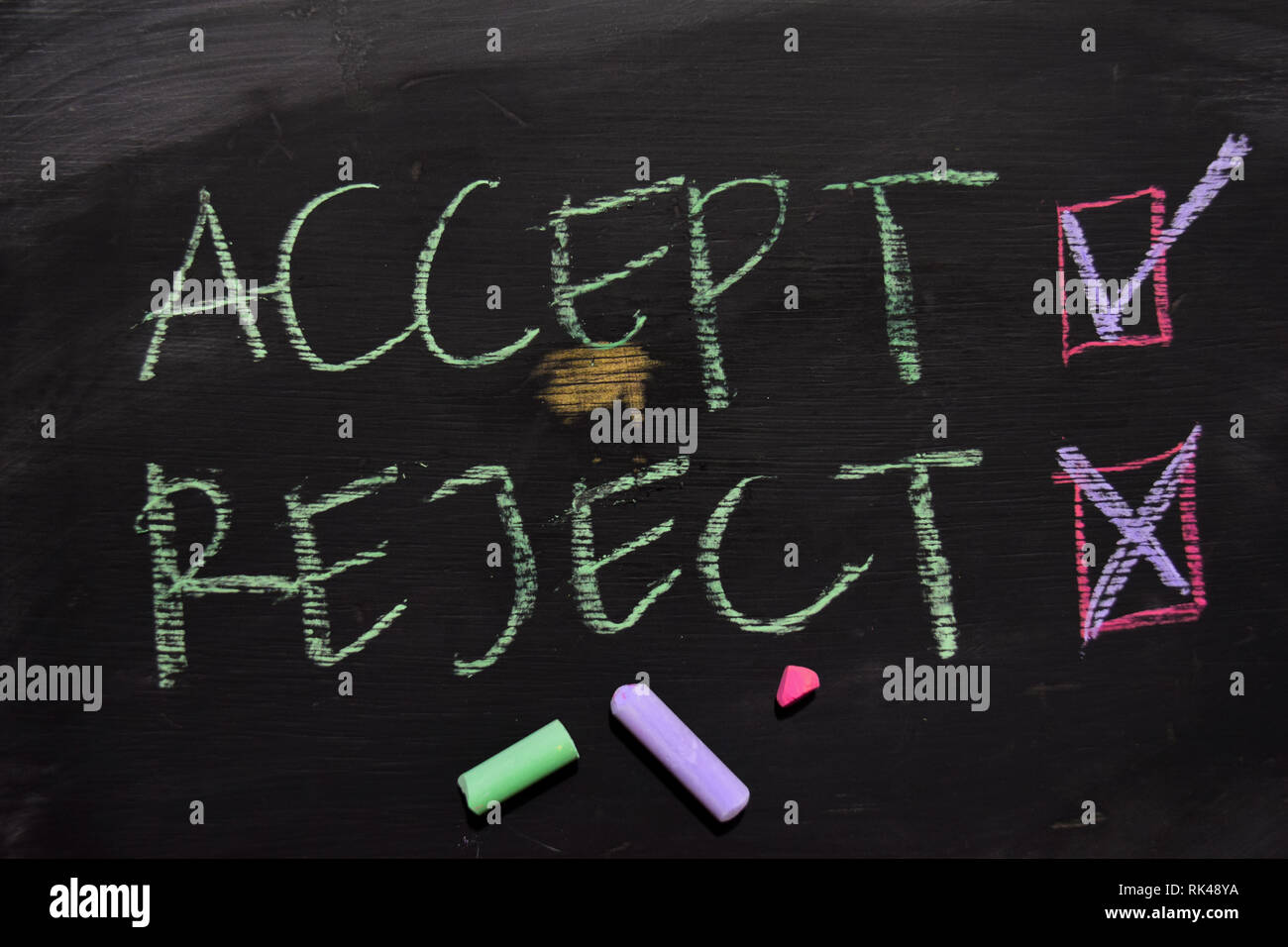 Accept or Reject written with color chalk concept on the blackboard ...