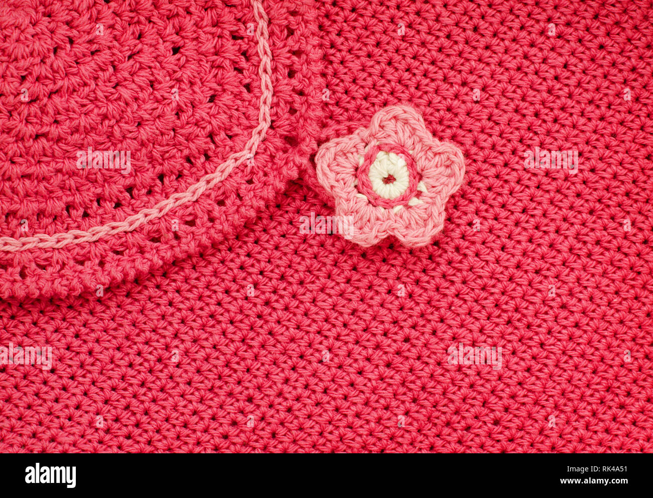 Closeup of red crochet fabric with flower button for background Stock ...