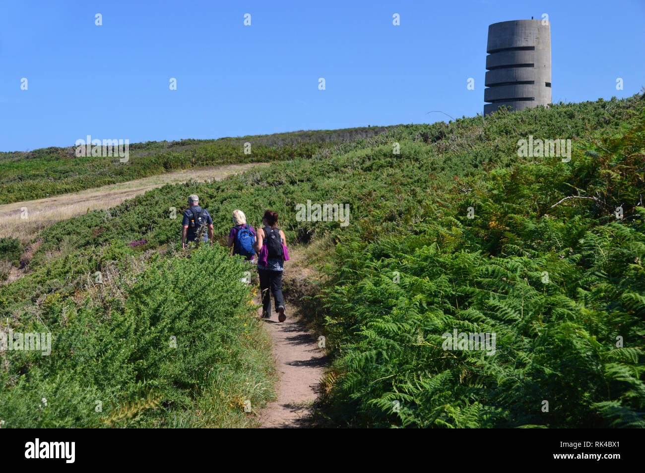 Three Hikers Walking on the Coastal Footpath to the WW2 German ...