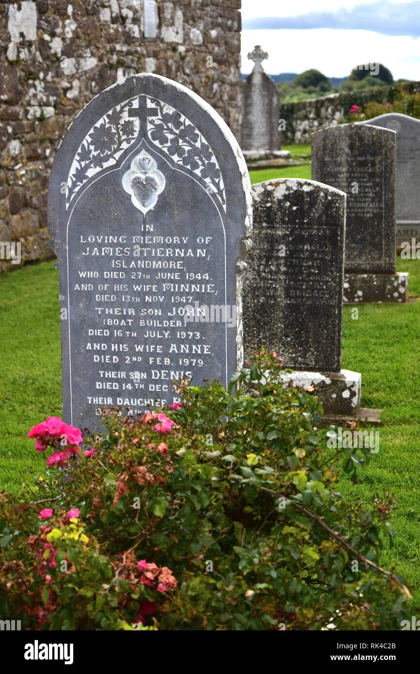 Tombstones with inscriptions on a cemetery on Holy Island in Lough Derg ...