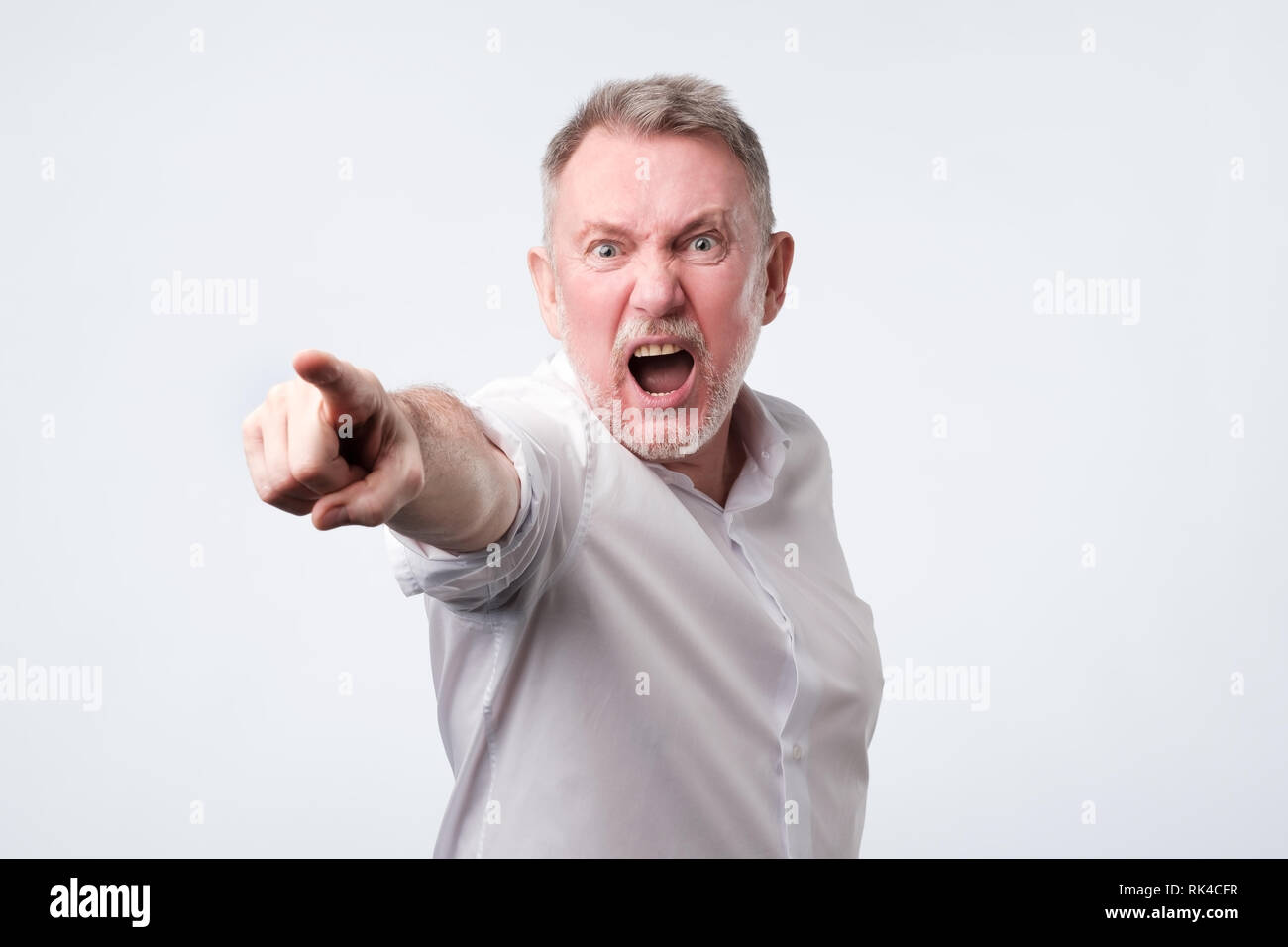 Screaming senior man in white shirt. Negative facial emotion Stock ...