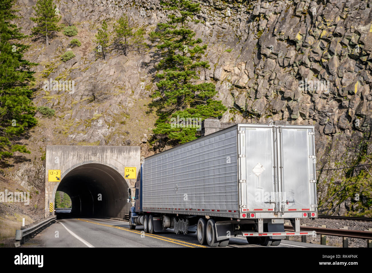 Big rig long haul blue American semi truck transporting commercial ...
