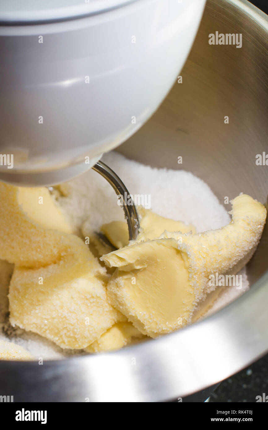 Mixing butter and sugar in mixing machine, homemade bakery, close up ...