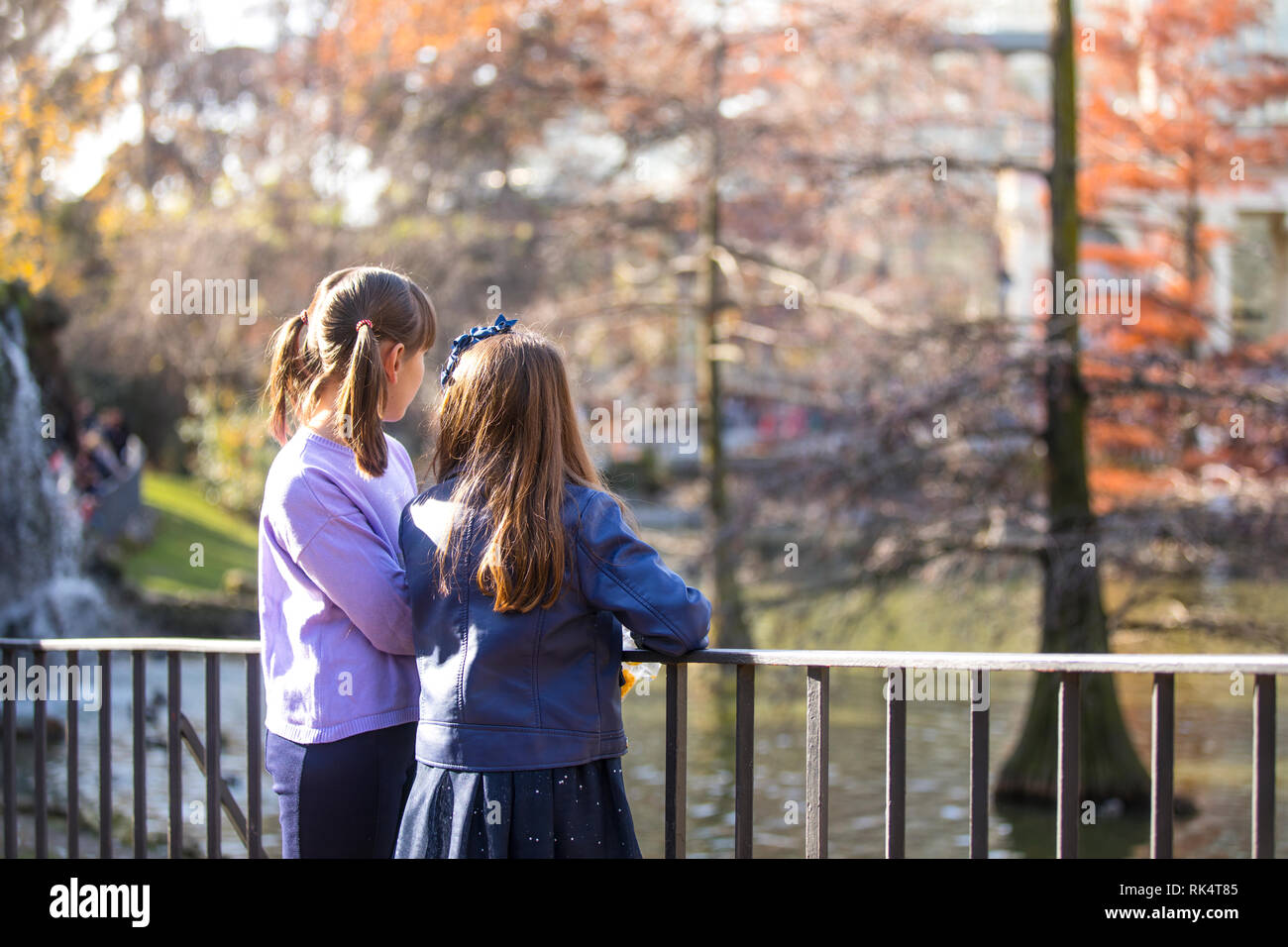 Two girlfriends having fun in a public park in the fall Stock Photo - Alamy