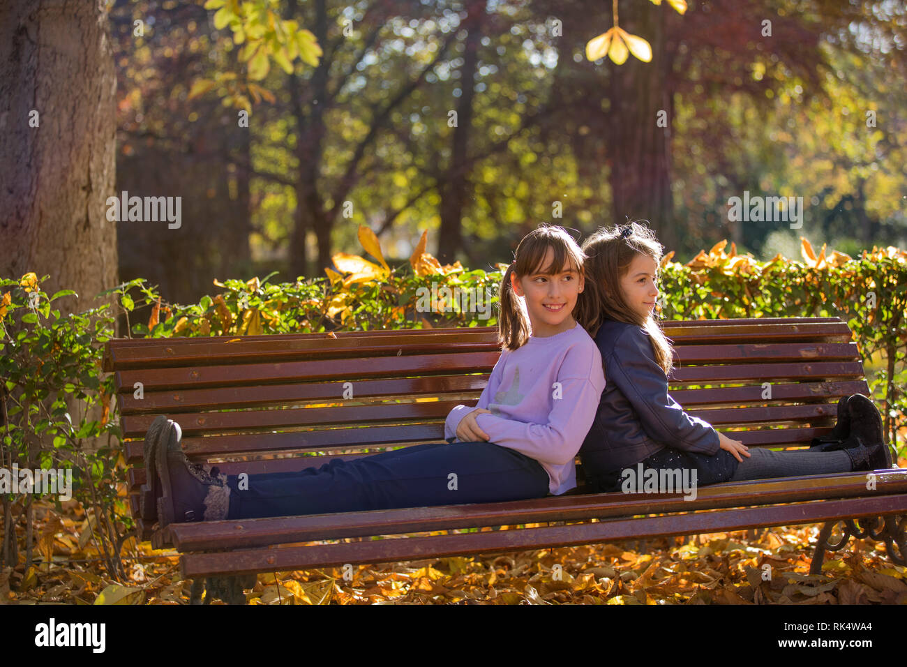 Two girlfriends having fun in a public park in the fall Stock Photo - Alamy