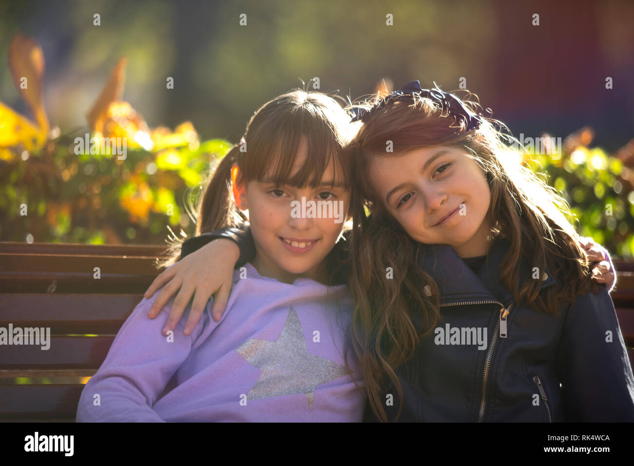 Two girlfriends having fun in a public park in the fall Stock Photo - Alamy