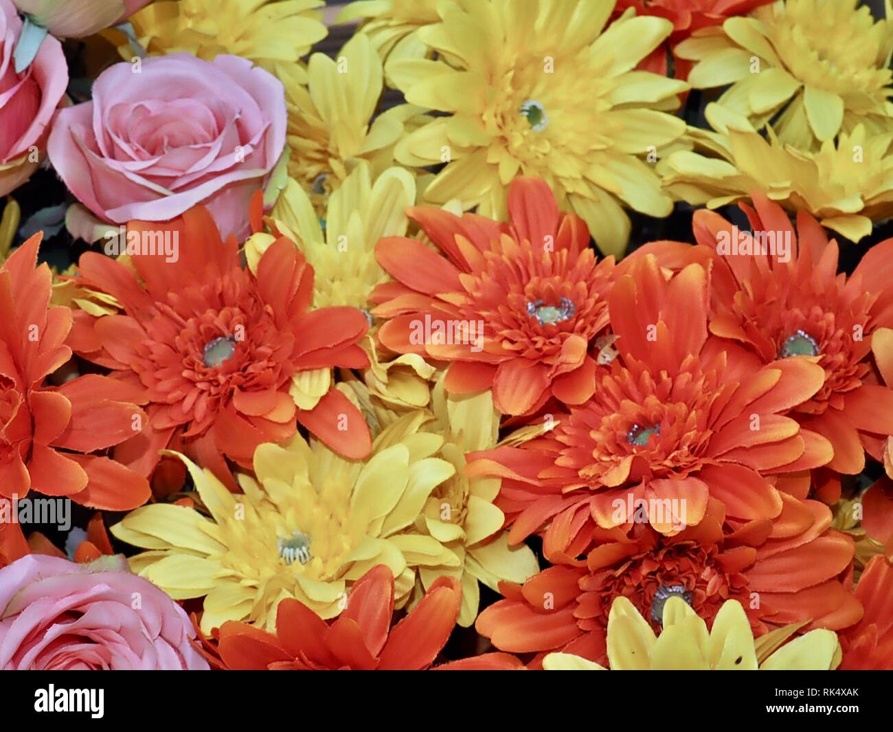 beautiful fabric flowers, flowers in yellow and red Stock Photo - Alamy