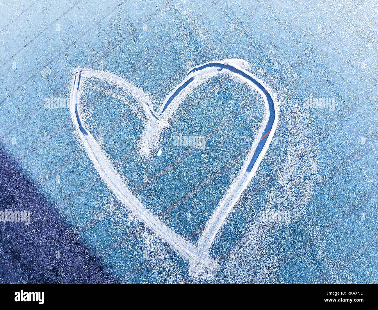 A heart symbol in the icy surface of a blue windshield Stock Photo - Alamy