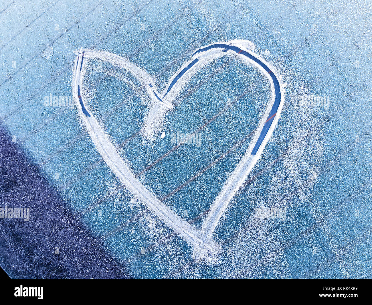 A heart symbol in the icy surface of a blue windshield Stock Photo - Alamy