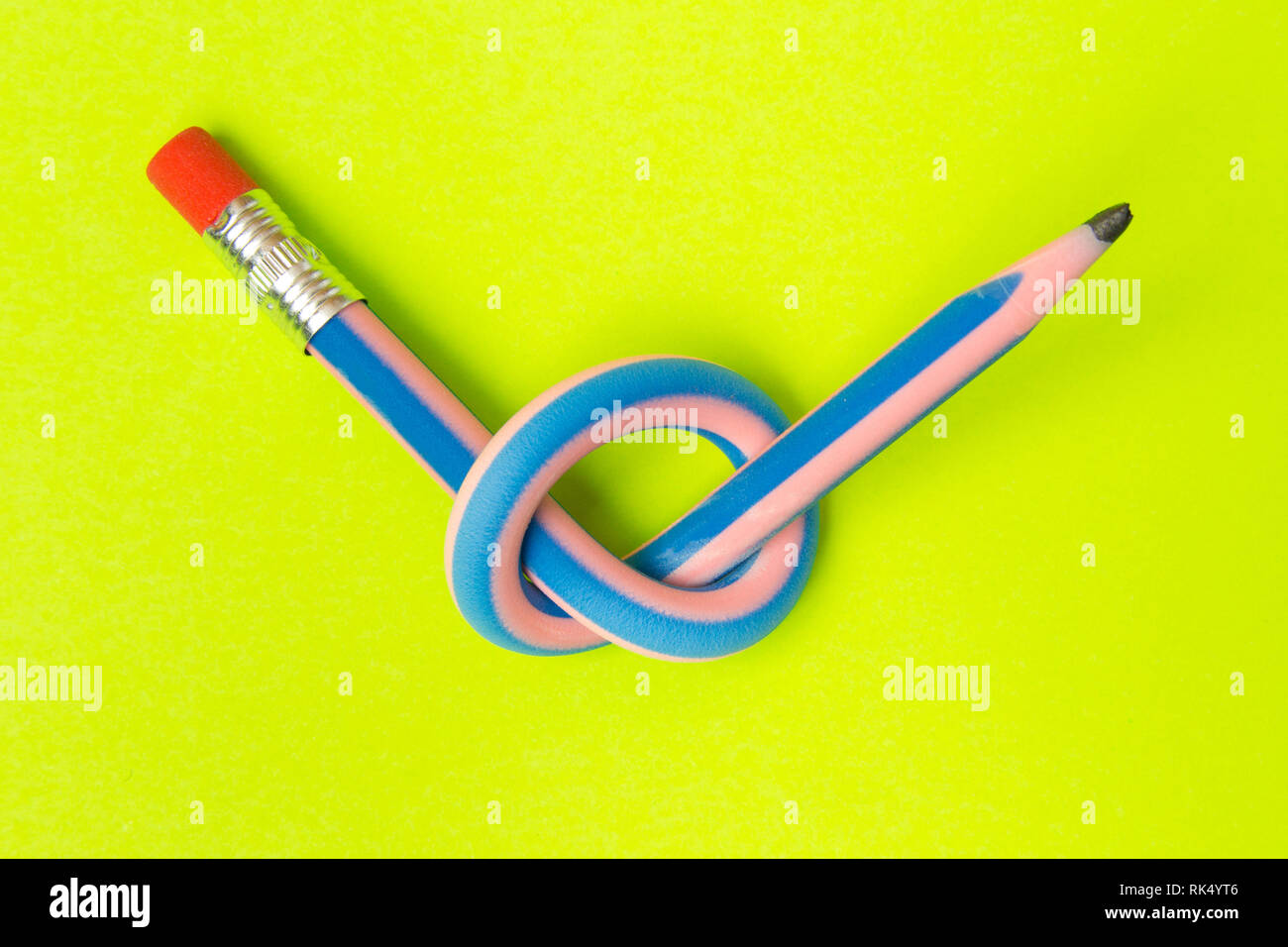 Flexible pencil on a green background. Bent pencils two-color. Business ...