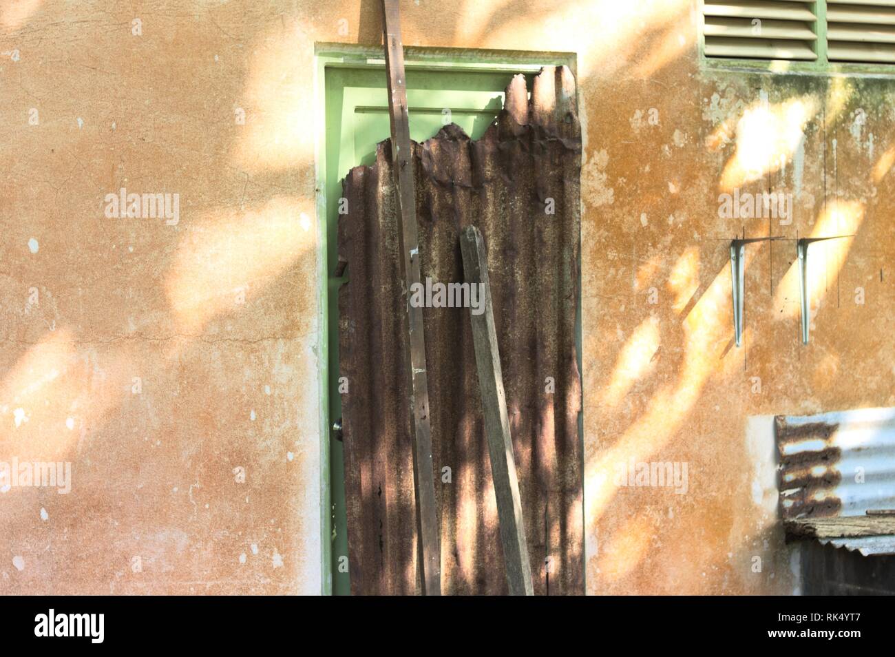Abandoned building entrance with a steel panel (Ari Atoll, Maldives ...