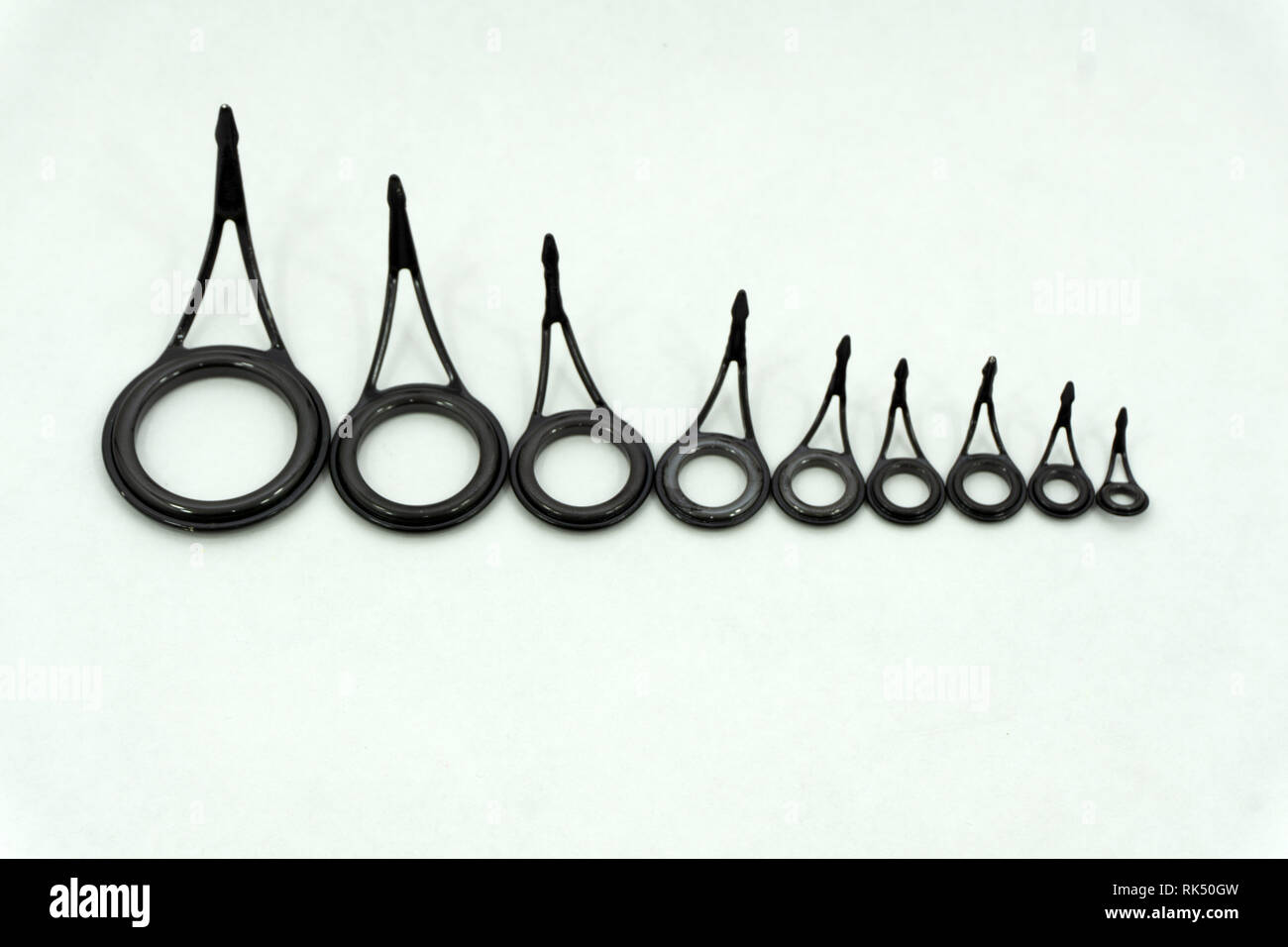 different fishing rods and reels on wooden boards background. creative ...