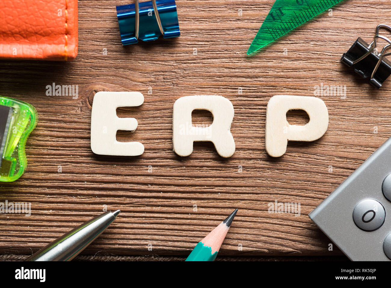 ERP word on wooden table and office stationary around Stock Photo - Alamy