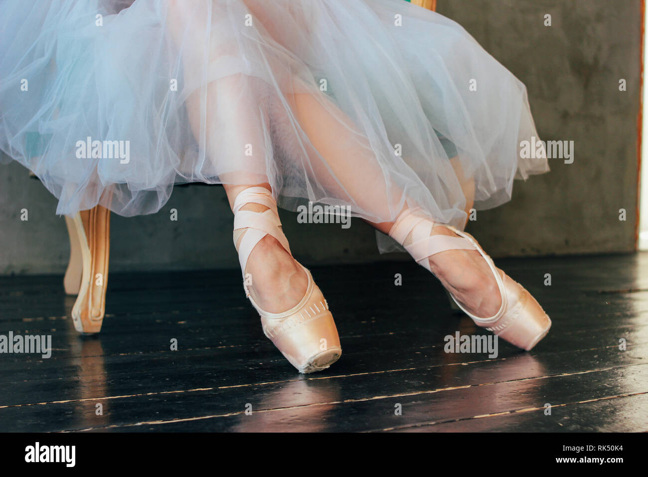 The ballerina ballet dancer in pointe shous sitting on the classic ...