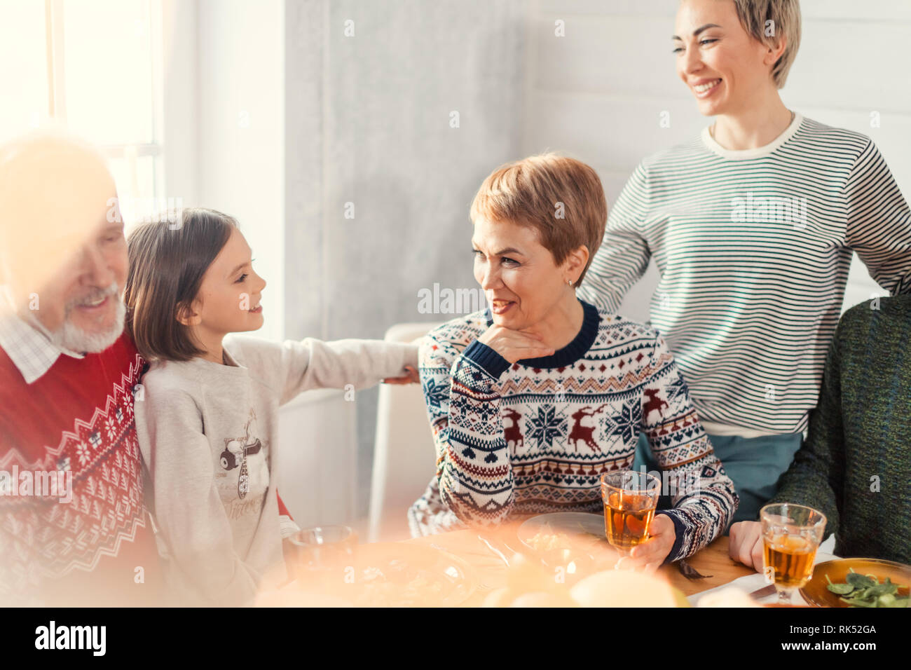 little adorable girl talking with her mother and aunt during the ...