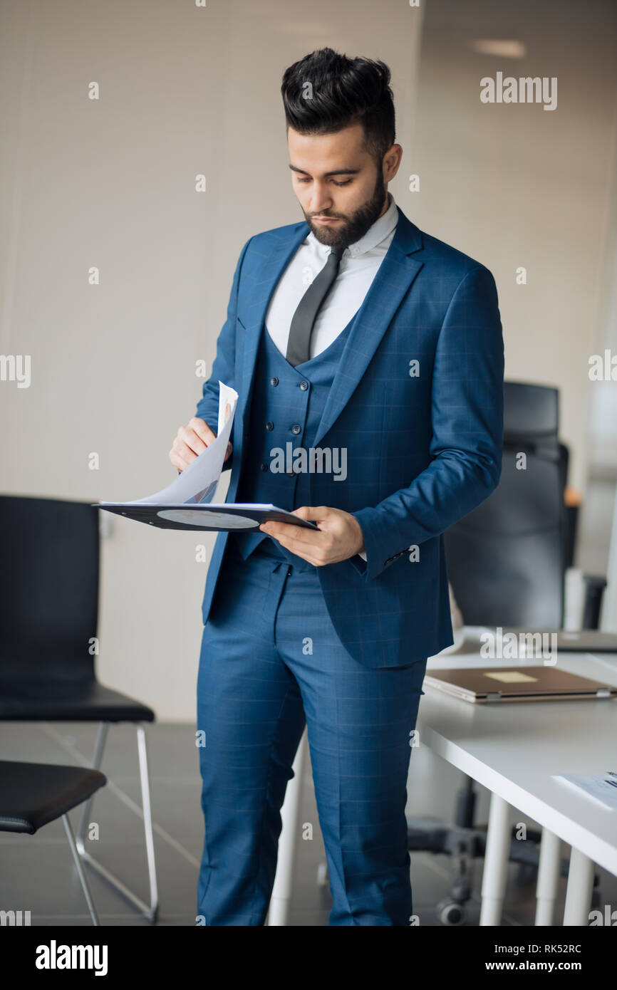 stylish manager is checking documents, paper. side view photo Stock ...