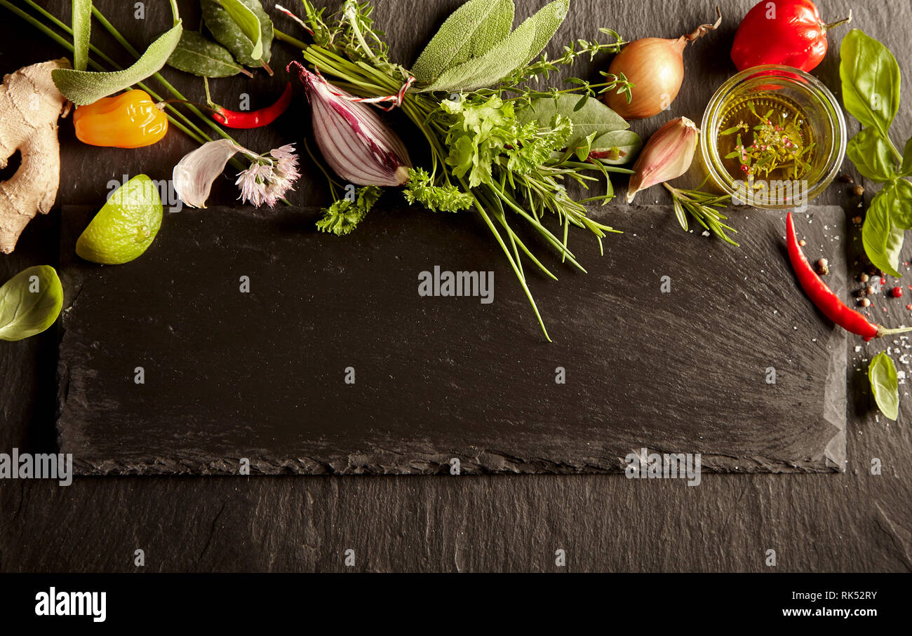 Fresh herbs, spices and vegetables in kitchen ingredients layout on ...