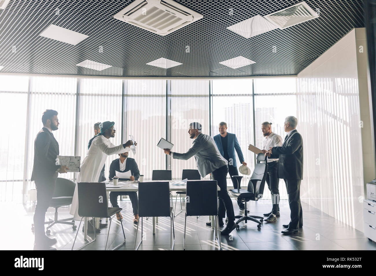 Multiethnic business men dressed in formal wear and national arabian ...