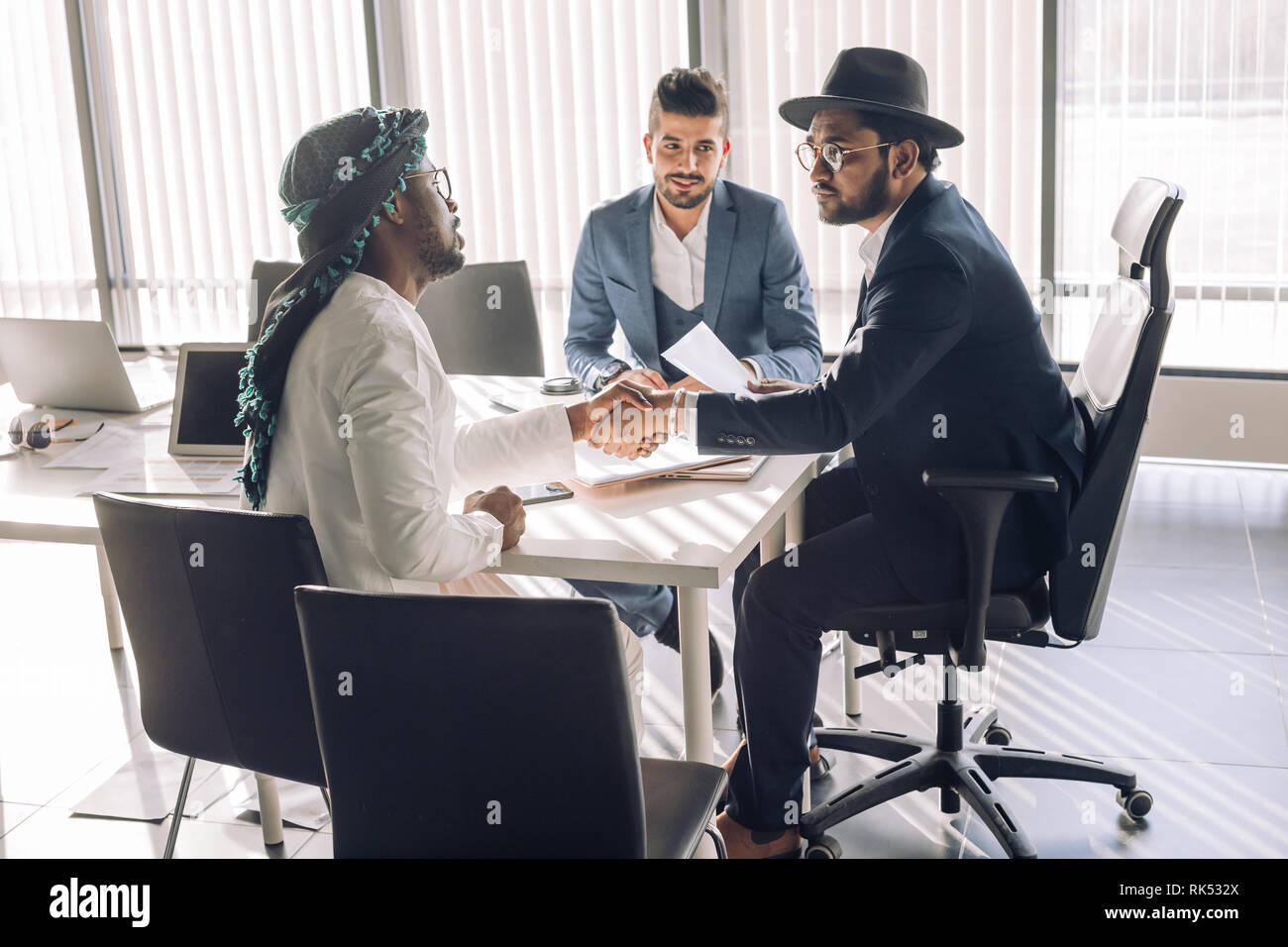Multiracial Business men making handshake in office meeting. Business ...