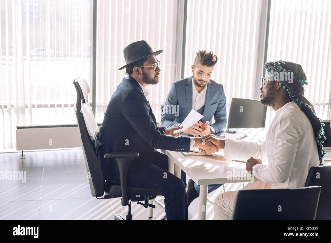 Multiracial Business men making handshake in office meeting. Business ...