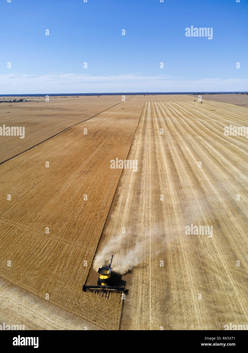 Aerial of barley harvesting with a modern wide comb combine harvester ...