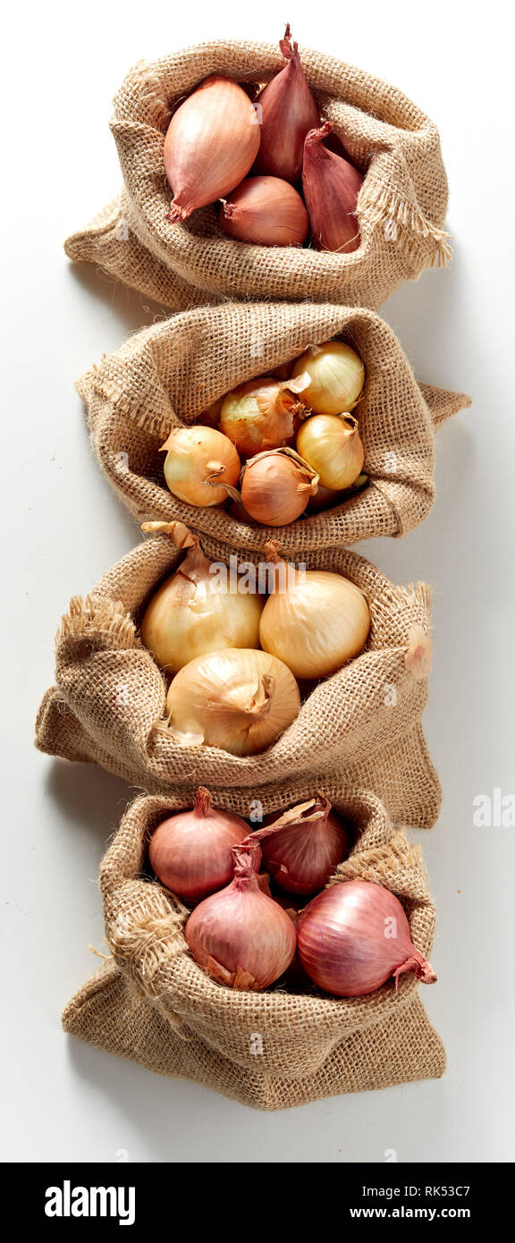 Vertically arranged row of burlap sack bags with different kind of ...