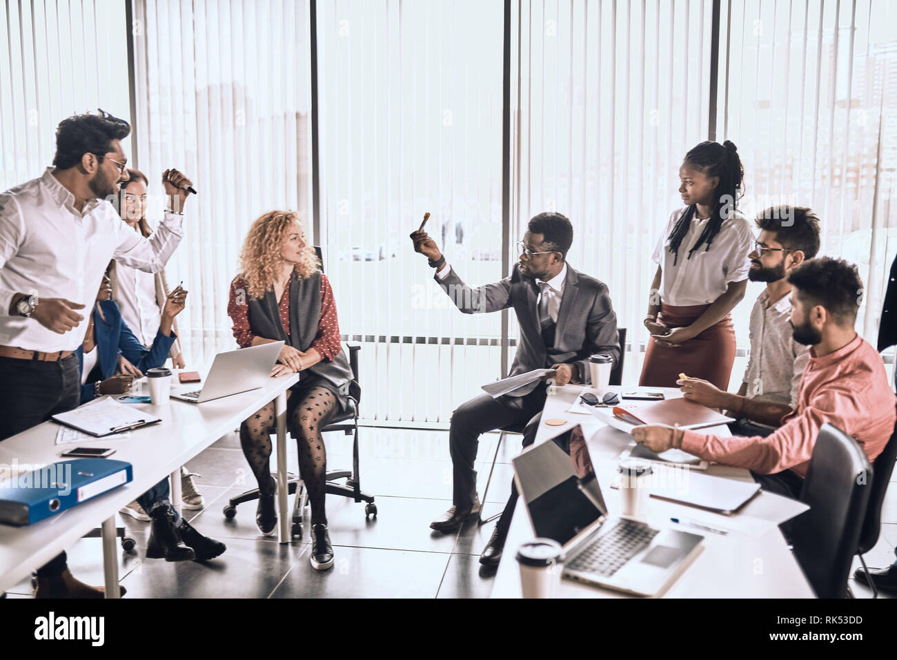 friendly argument among colleagues. two groups of managers proving ...