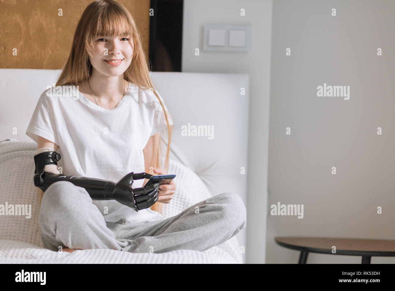 pretty disabled girl dressed casually looking at the camera. copy space ...