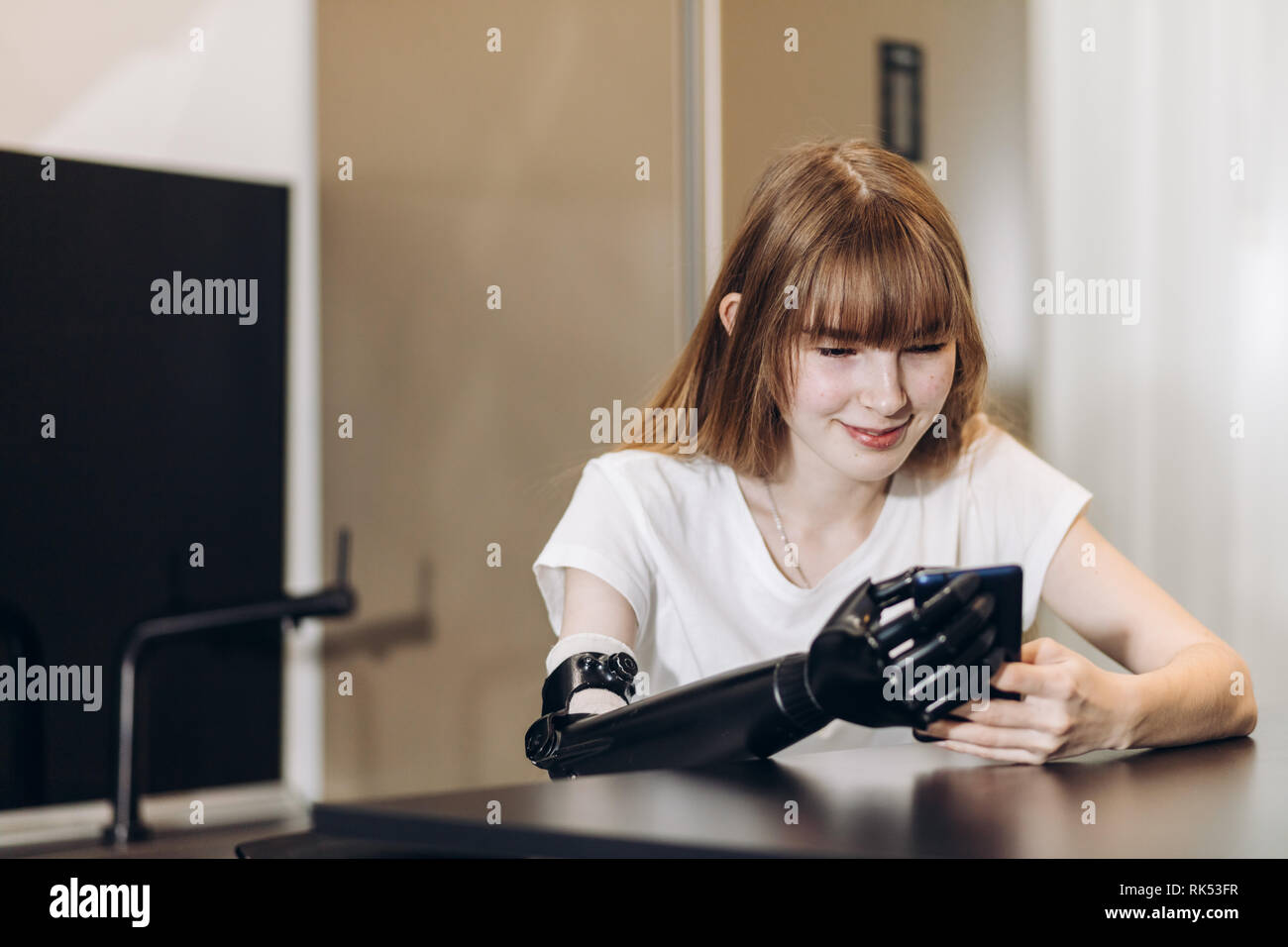 happy girl is holding a gadget and using it without difficulties. close ...